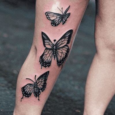Three butterfly tattoo on leg